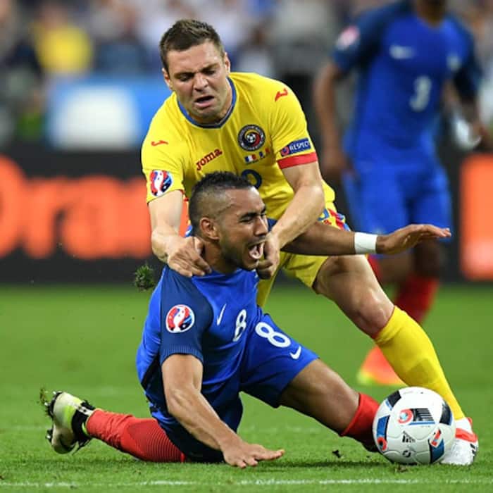 Adrian Popa tackles Dimitri Payet during France vs Romania in UEFA Euro ...