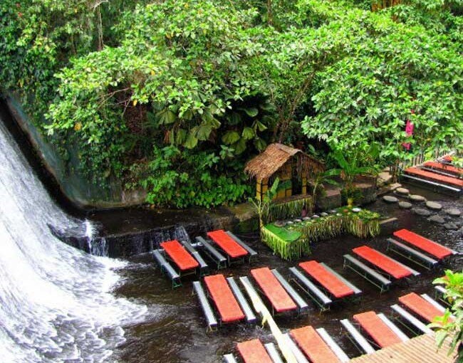 Bamboo tables at Labassin Waterfall Restaurant in Philippines