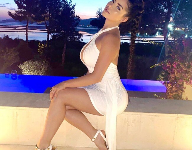 Demi Rose’s Sultry Pose in White Outfit