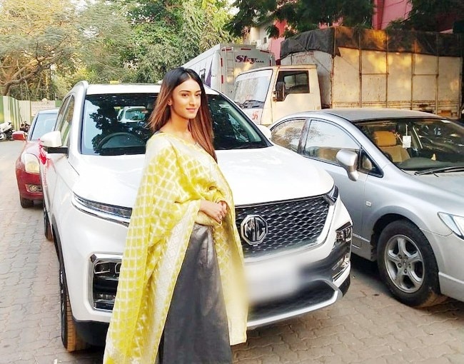 Erica Fernandez Posing With Her Car