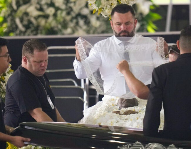 Funeral service workers unveil the coffin of Brazilian soccer great Pele