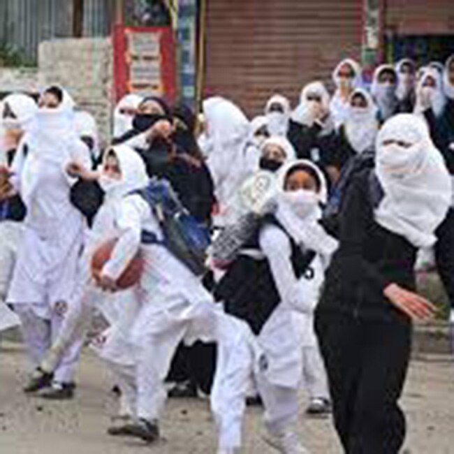 Girls throwing stones at police force in Kashmir