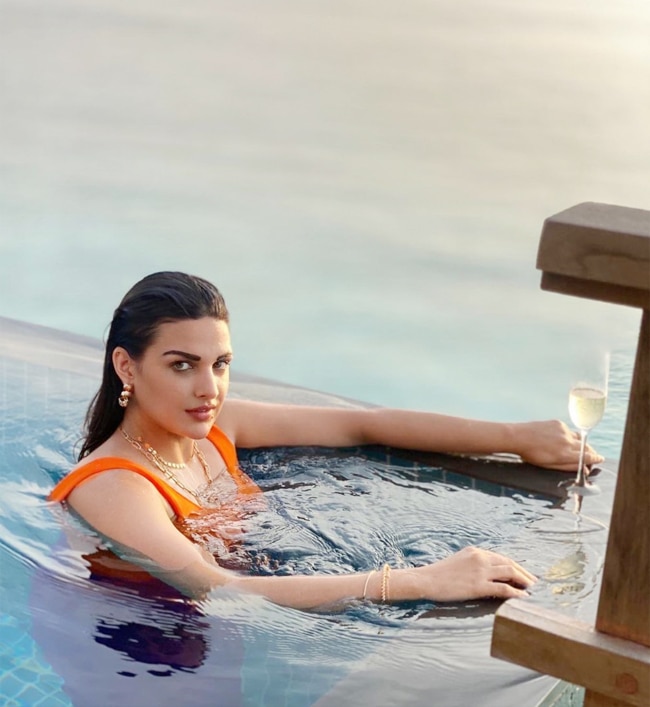 Himanshi Khurana strikes a pose in an orange cami inside the pool, fans call her queen