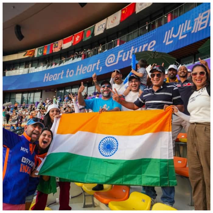 Indian fans celebrate after the women's cricket team win historic gold.