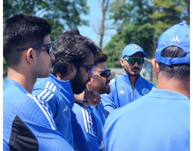 Indian players engage in a team huddle ahead of their first training ...