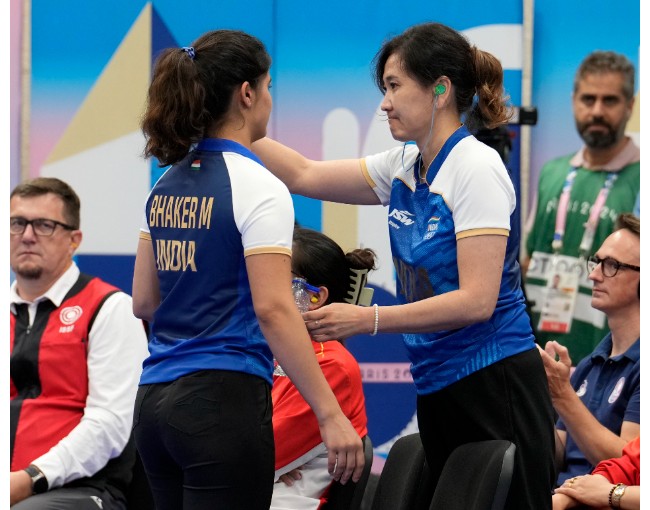 India's Manu Bhaker is consoled by her coach after getting eliminated.