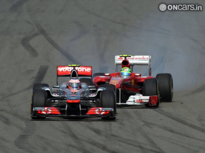 Jenson Button of Great Britain and McLaren drives in for a pitstop