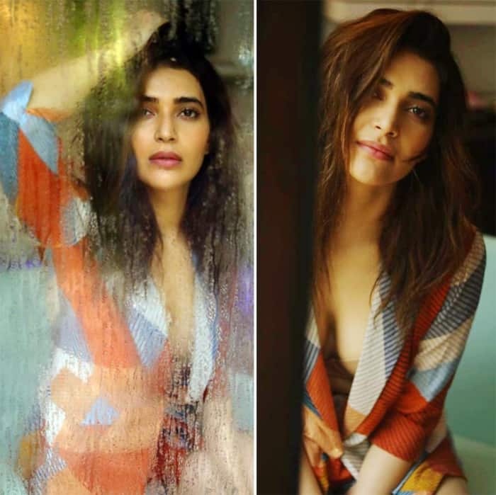 Karishma Tanna looks through a glass window as she models for a designer label