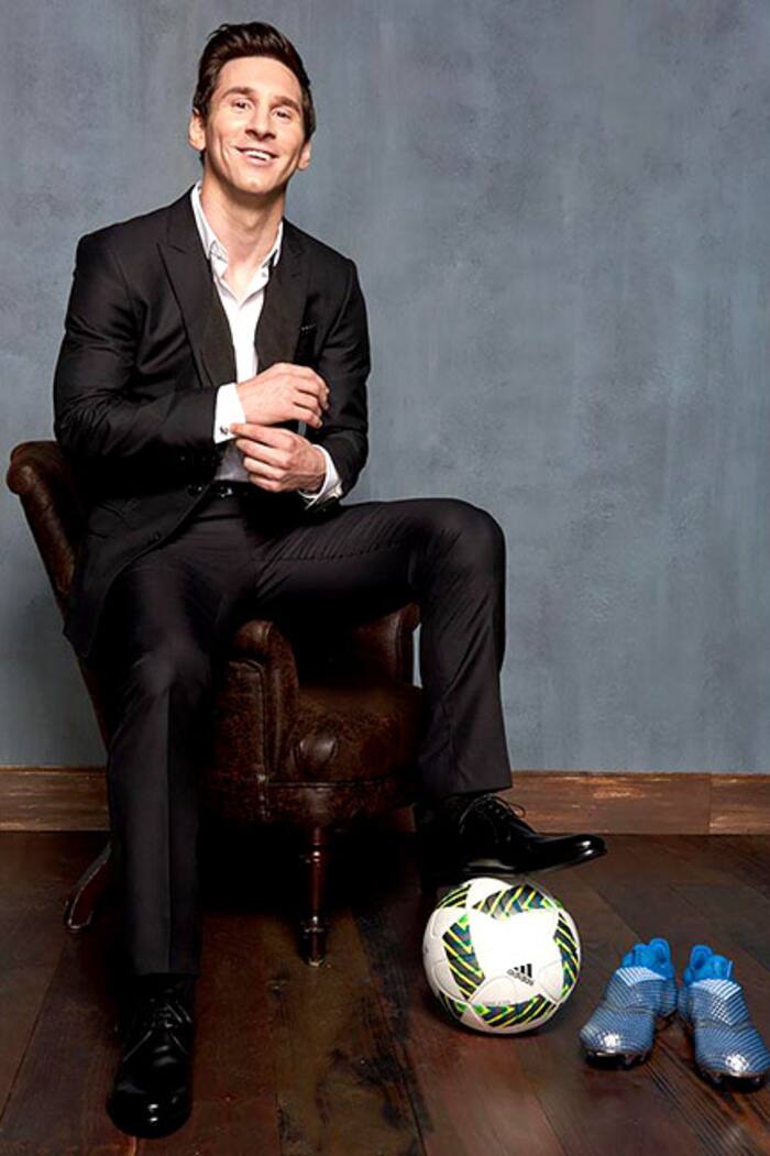 Lionel Messi poses with a football for Sports Illustrated magazine