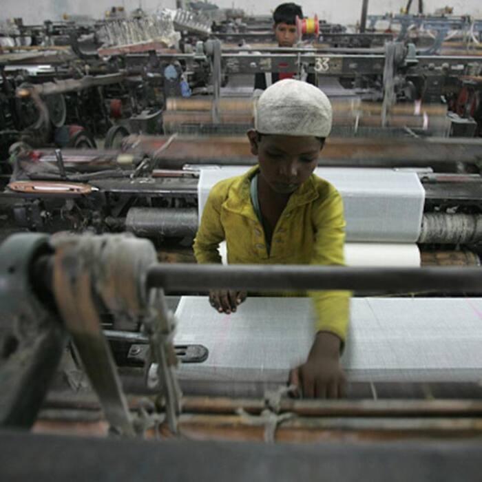 Young boy working in a steel factory in Dhaka