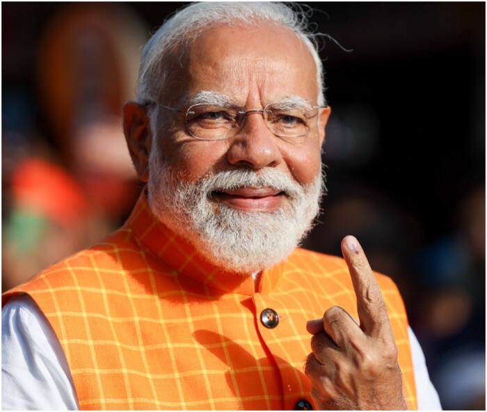 In PICS: PM Modi Votes In Ahmedabad, Signs His Portrait While ...