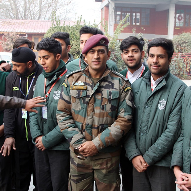 MS Dhoni poses with the students during his visit to DPS Srinagar