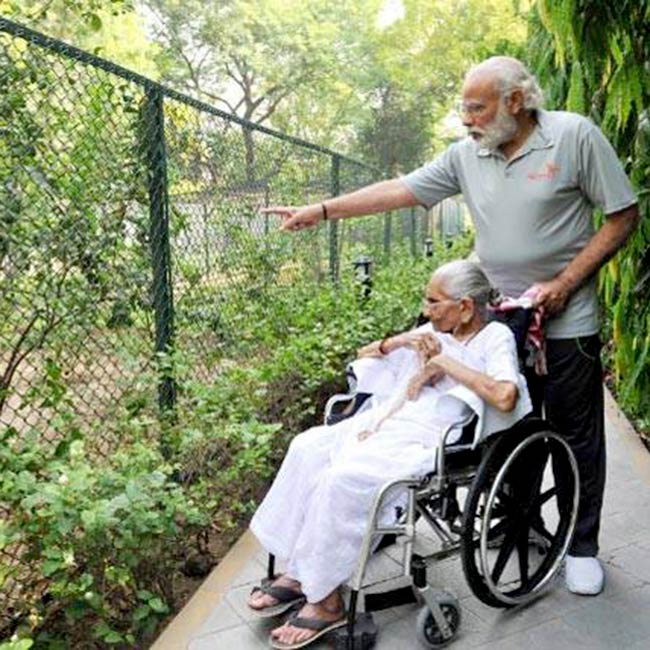 Narendra Modi touching mother Heeraben Modi’s feet