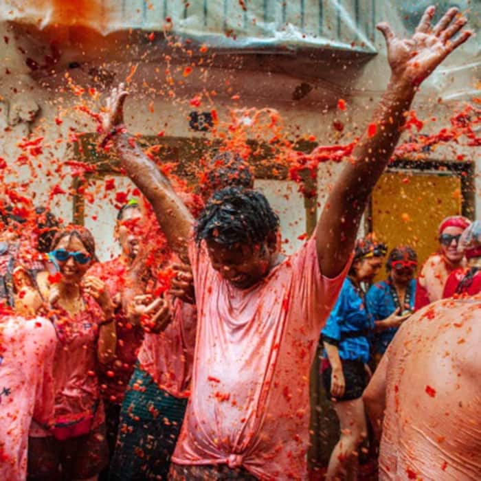 People celebrating La Tomatina Festival in Spain with full energy