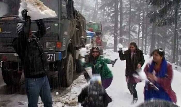 Tourists enjoy fresh snowfall.