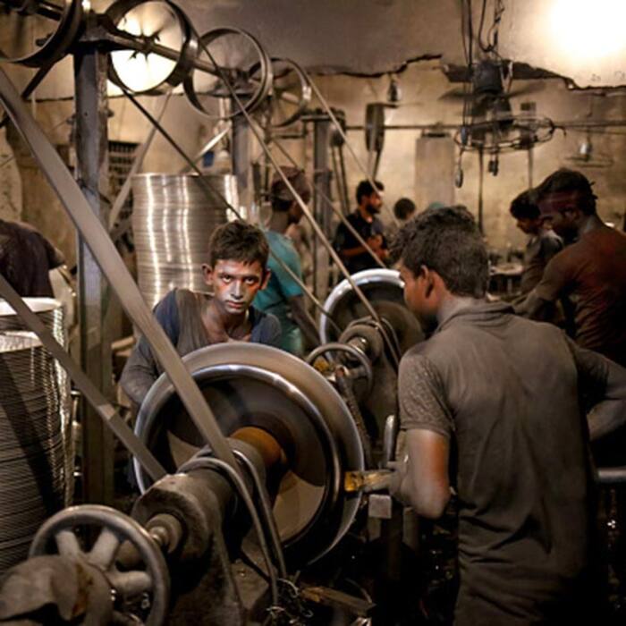 Young boy working in a steel factory in Dhaka